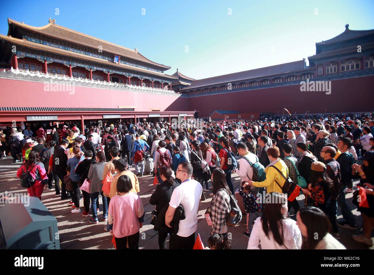 Crowds of Chinese tourists queue up to visit the Palace Museum, also ...