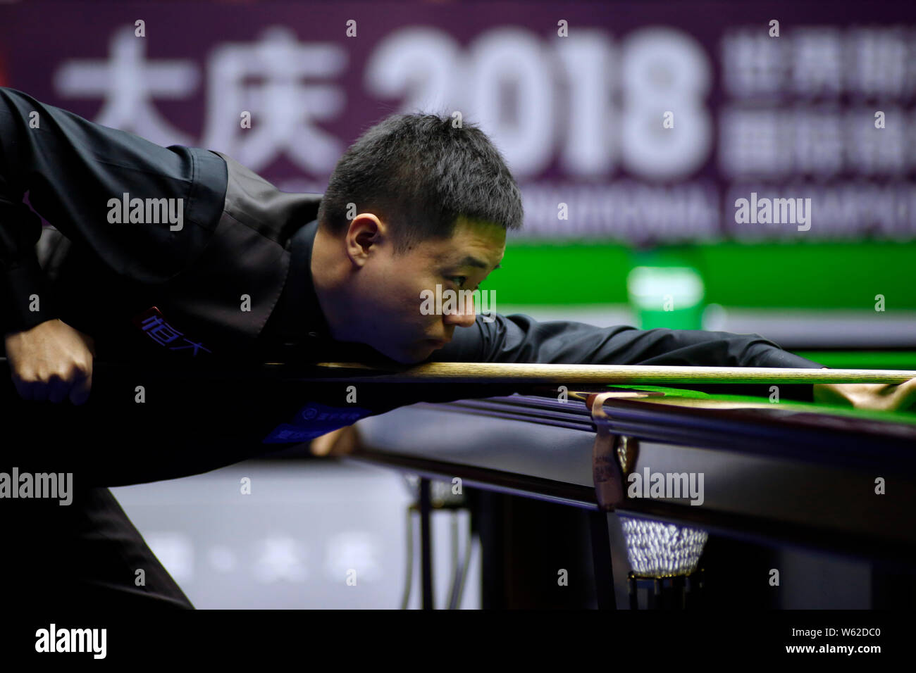 Ding Junhui of China plays a shot to Robin Hull of Finland in their ...