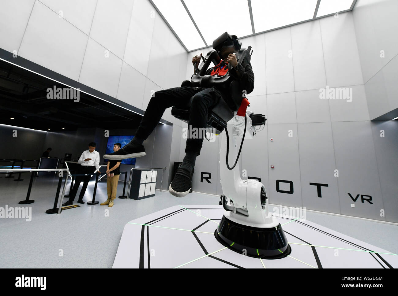 A visitor tries out a VR device to take a roller coaster ride at the ...