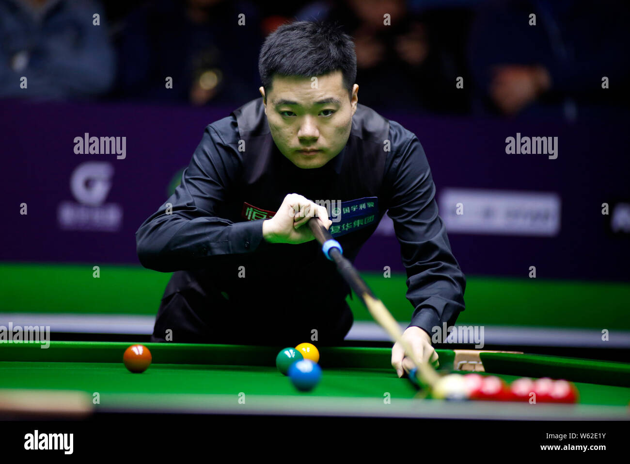 Ding Junhui of China plays a shot to Robin Hull of Finland in their ...