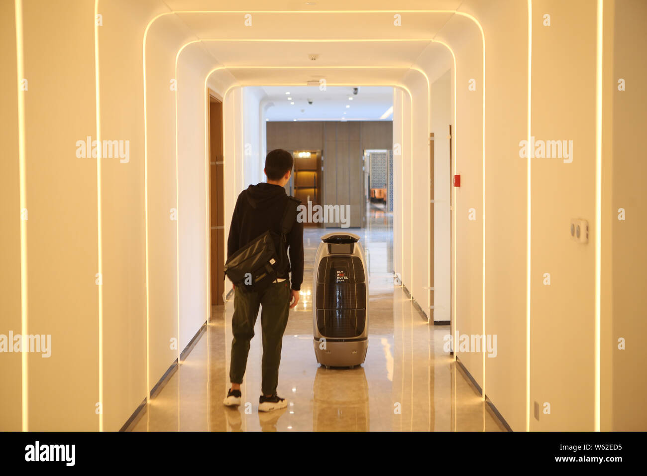 An intelligent robot serves at the Alibaba Future Hotel - Fly Zoo Hotel ...