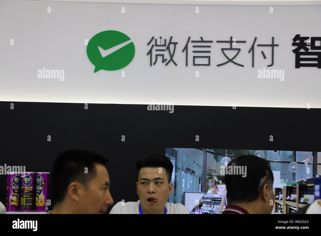 --FILE--People visit the stand of the messaging app Weixin, or WeChat ...
