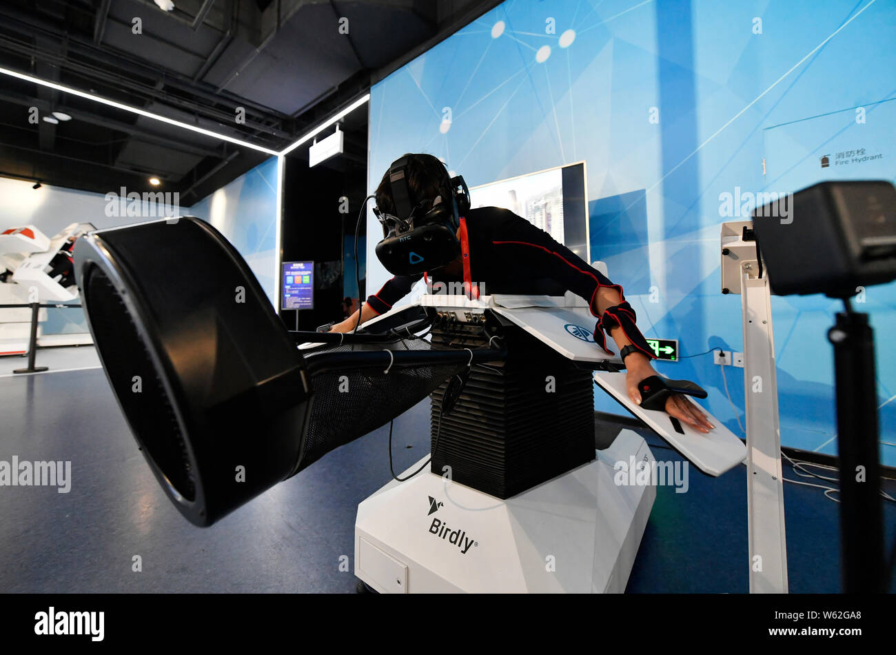 A visitor tries out a VR device to play a game at the SoReal VR ...