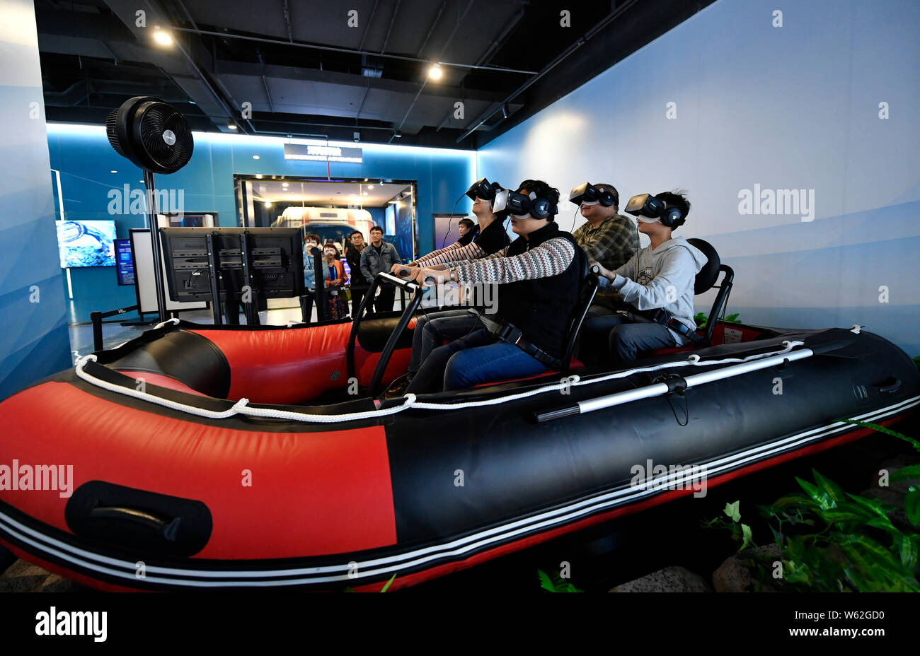 Visitors try out VR devices to ride a hovercraft at the SoReal VR ...