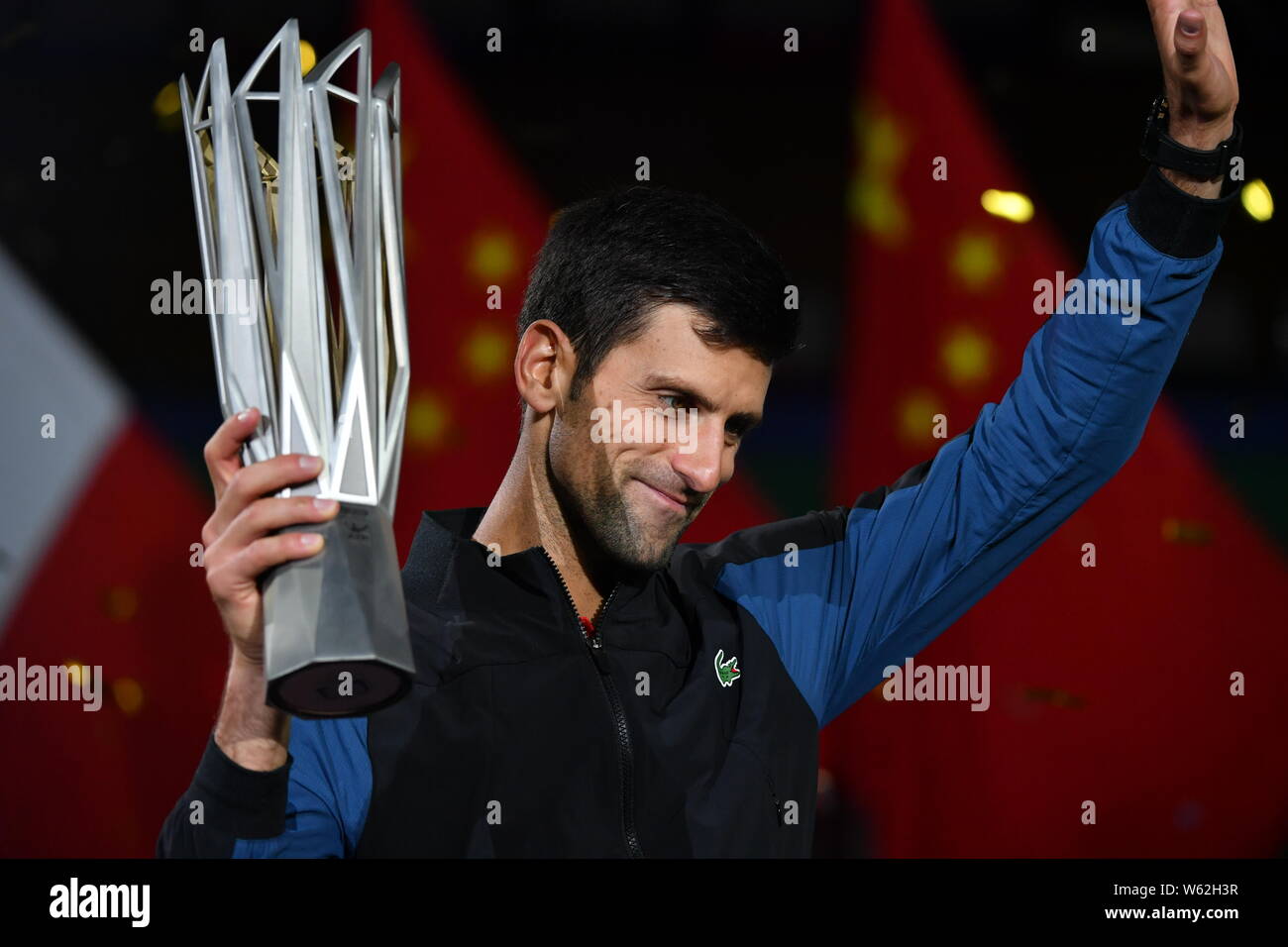 Novak Djokovic of Serbia poses with his champion trophy after defeating ...