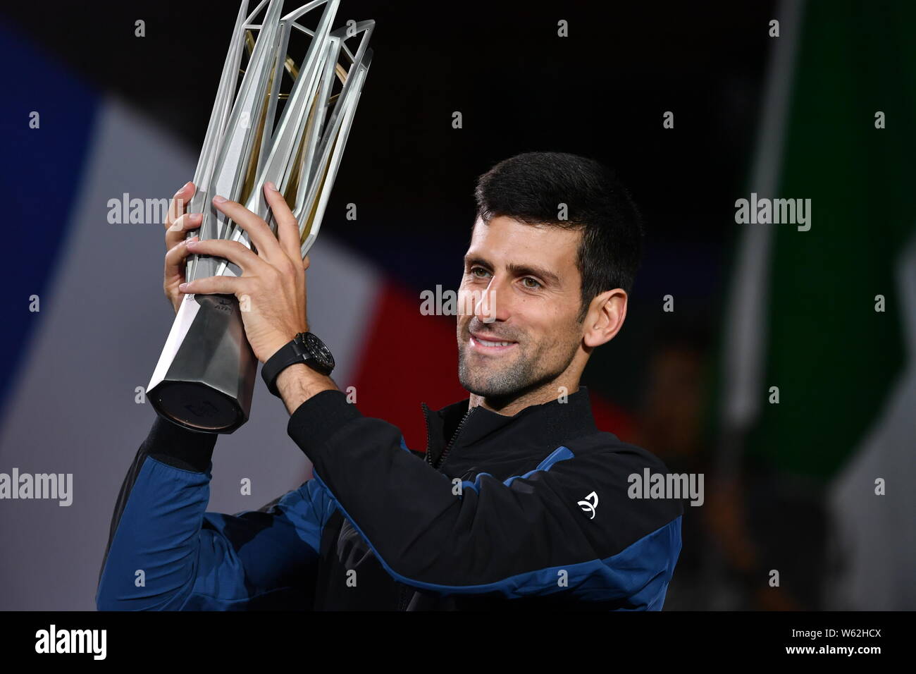 Novak Djokovic of Serbia poses with his champion trophy after defeating ...