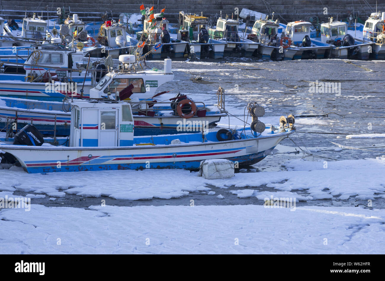 snow covered sea and fishing boat Stock Photo - Alamy