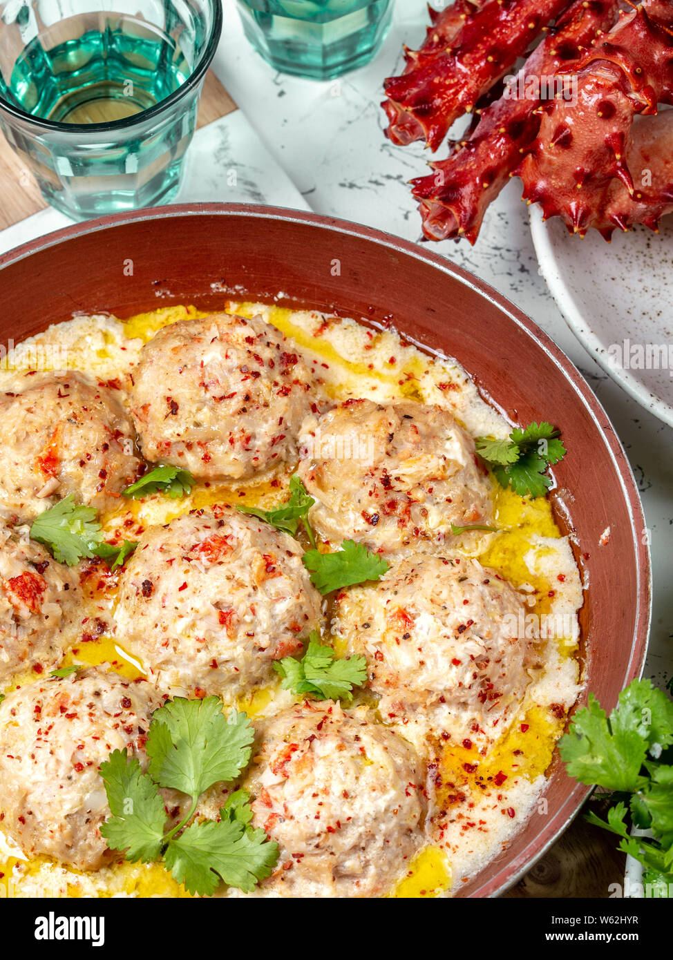 CRABMEATBALLS crab meatballs in white creamy sauce in red pan, whole ...