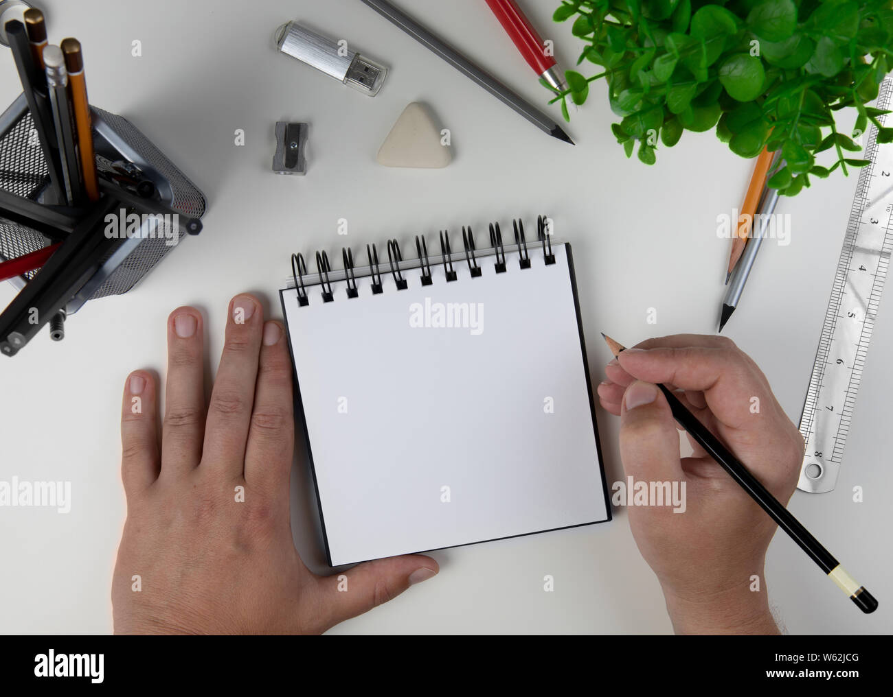 Human hand with pencil prepare to writing on notebook Stock Photo - Alamy