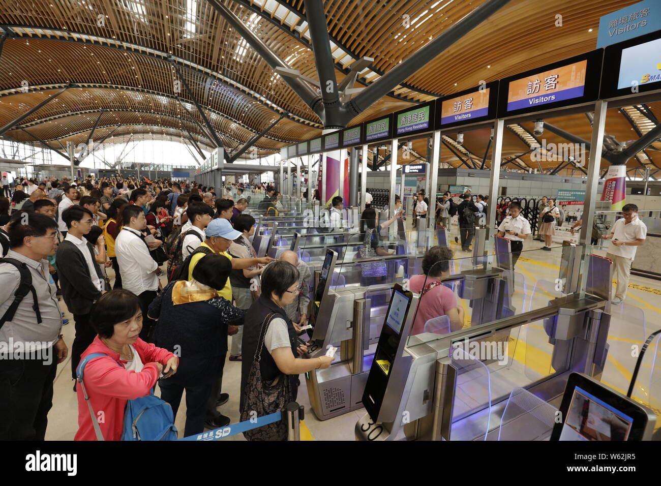 Passengers queue up to take a coach from Kwoon Chung Bus over the world ...
