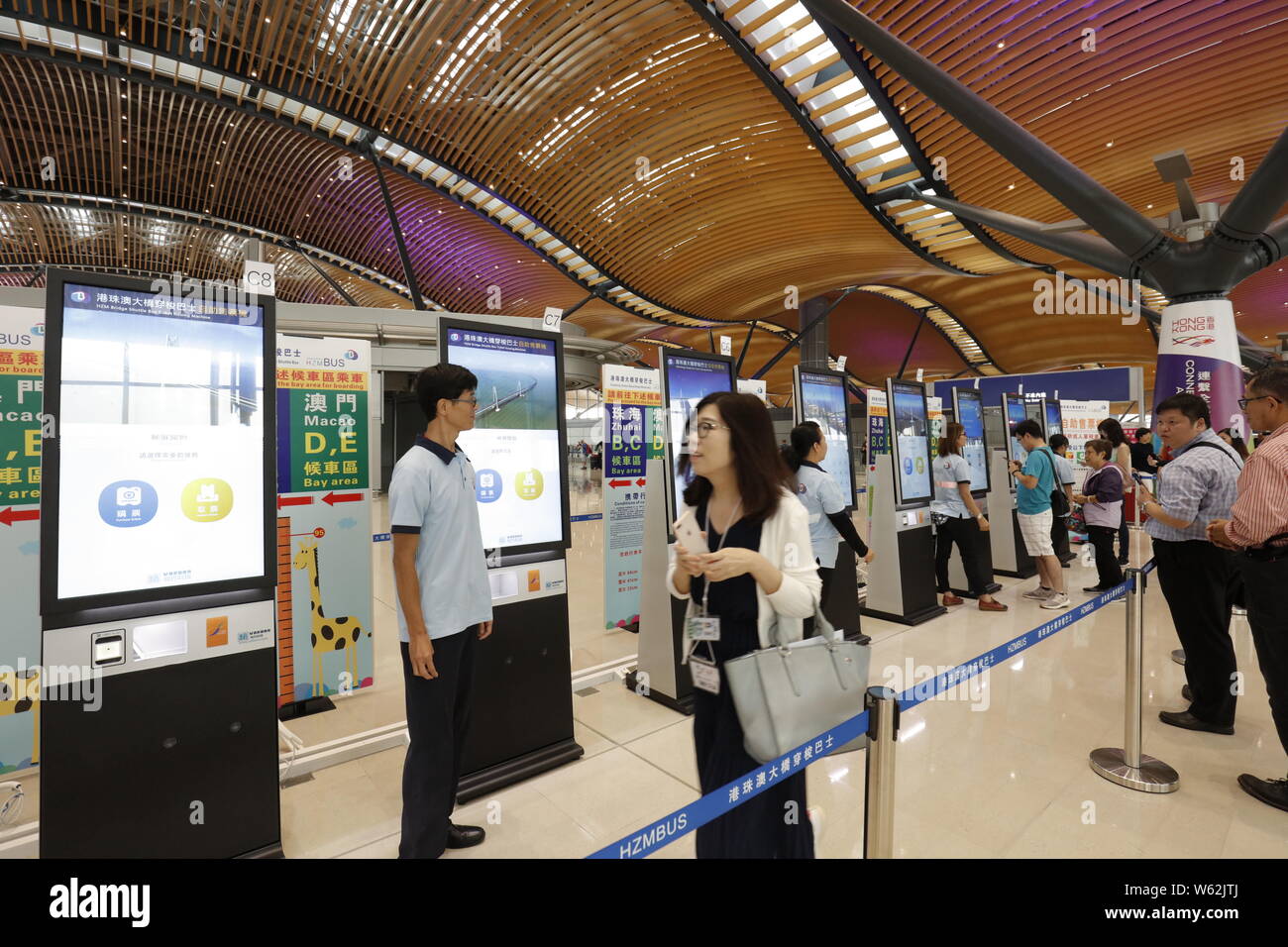 Passengers queue up to take a coach from Kwoon Chung Bus over the world ...