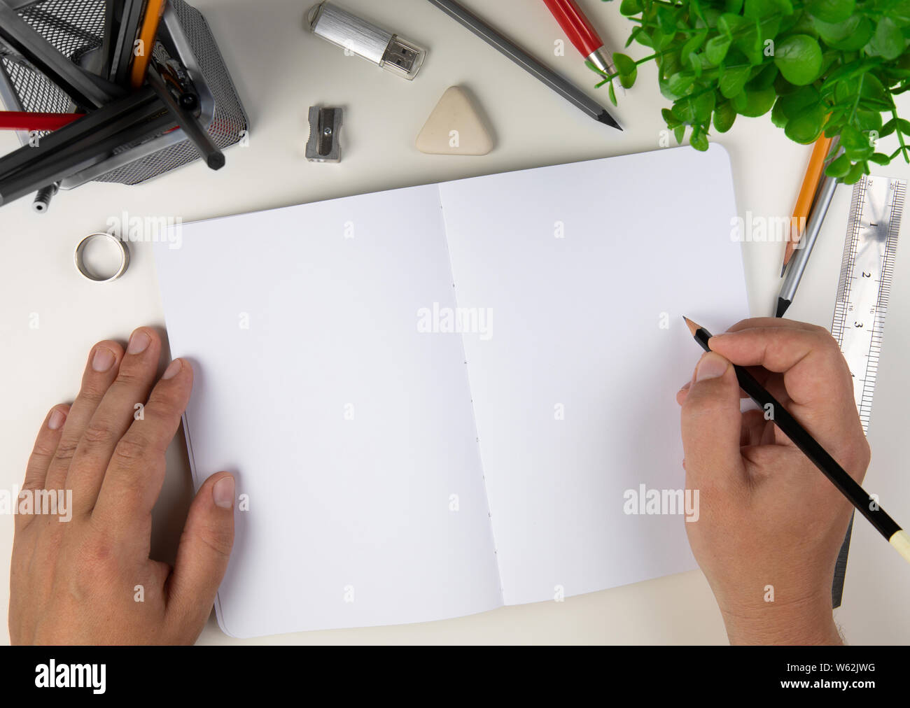 Human hand with pencil prepare to writing on notebook Stock Photo - Alamy