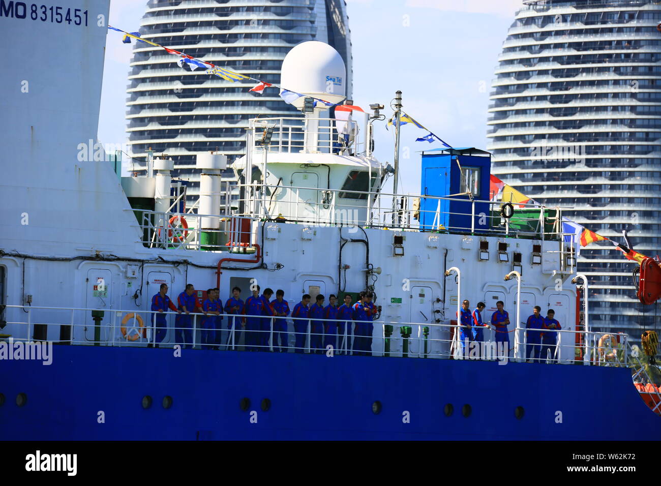 Scientists wave after the oceanic research vessel Tansuo-1, which ...