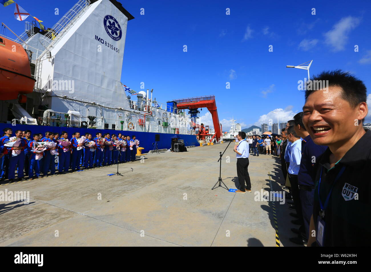 Scientists pose in front of the oceanic research vessel Tansuo-1, which ...