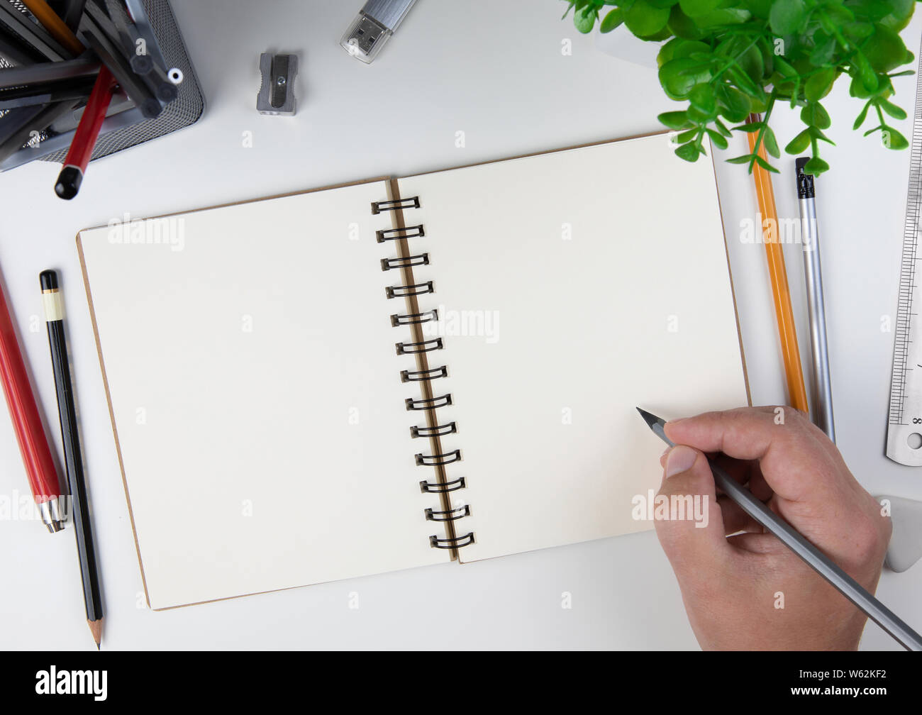 Human hand with pencil prepare to writing on notebook Stock Photo - Alamy