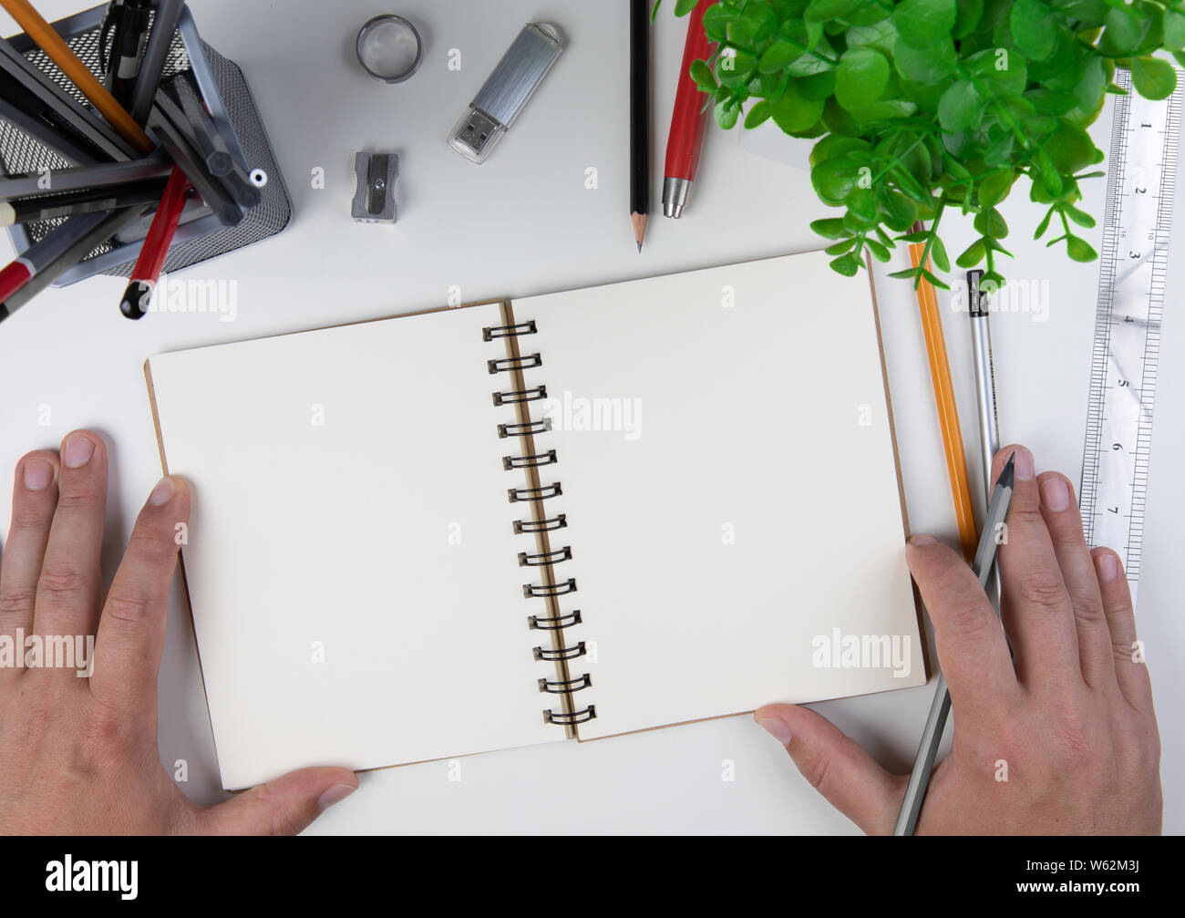 Human hand with pencil prepare to writing on notebook Stock Photo - Alamy