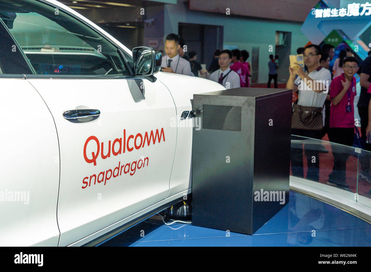 --FILE--People visit the stand of Qualcomm during an expo in Guangzhou ...