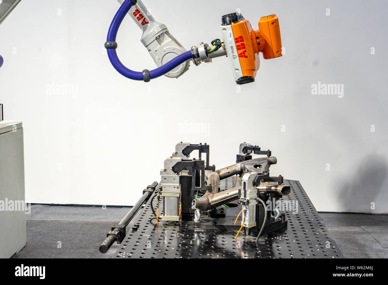--FILE--A robot arm is on display at the stand of ABB during the 20th ...