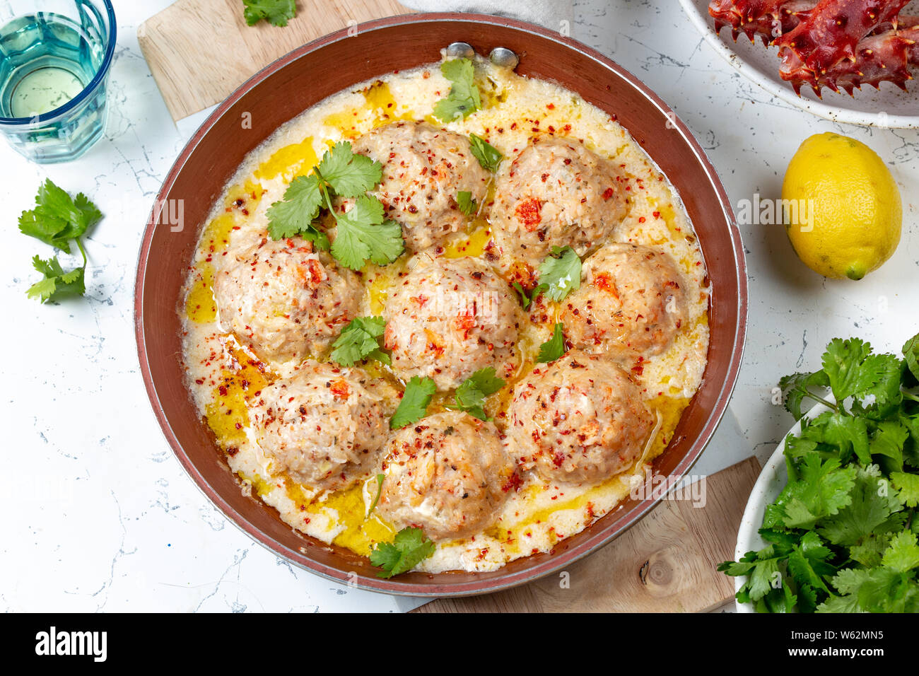 CRABMEATBALLS crab meatballs in white creamy sauce in red pan, whole ...