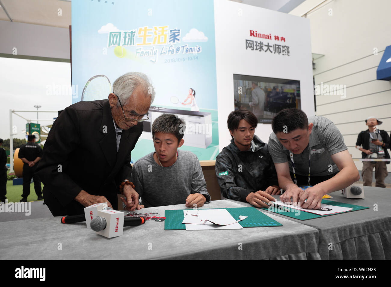 Chinese tennis player Hua Runhao, second left, and Japanese tennis ...