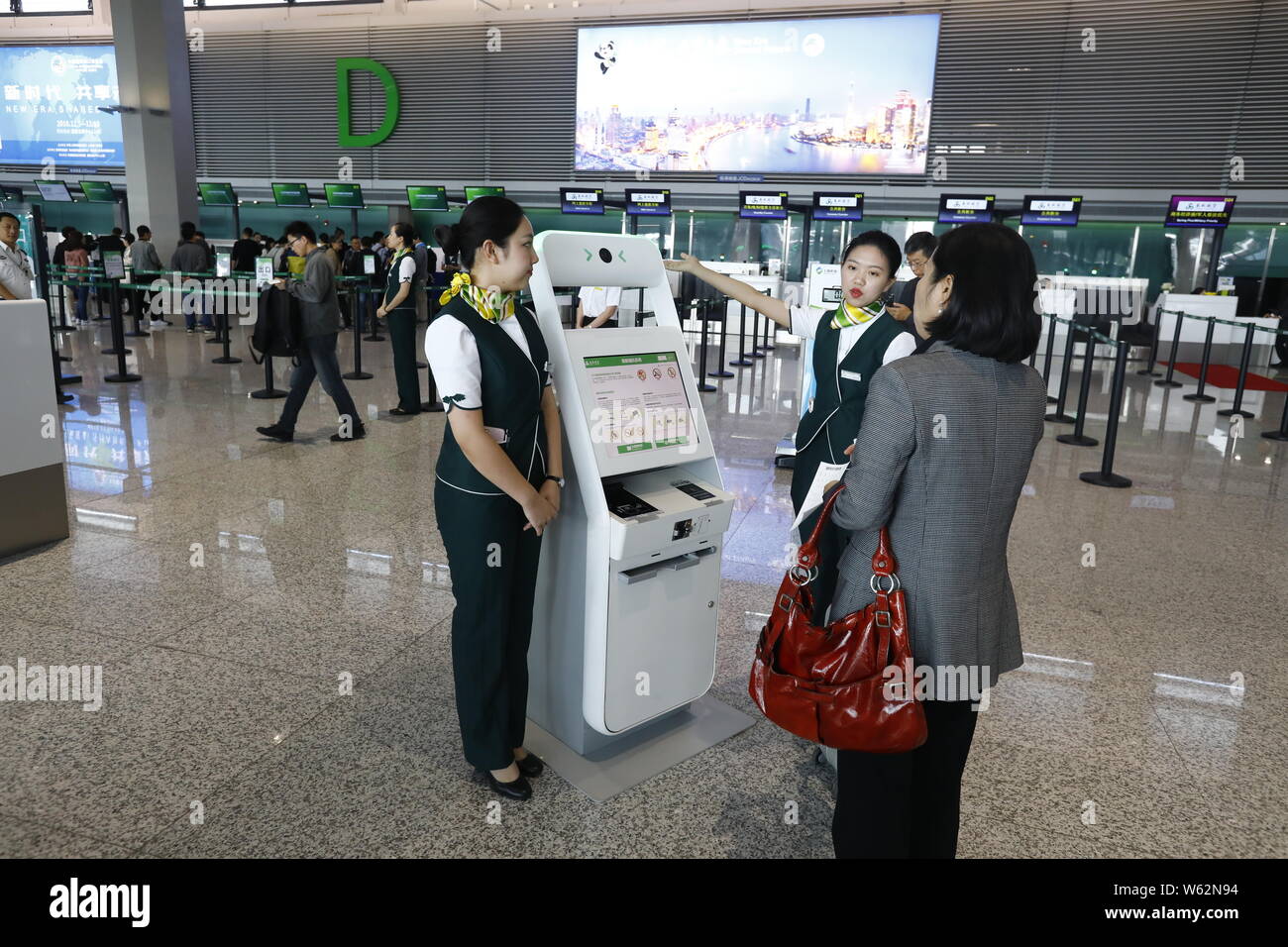 A passenger uses a self-service machine at the T1 terminal of Shanghai ...