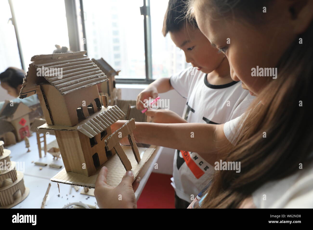 Chinese children and their teachers use recycled package boxes to make ...