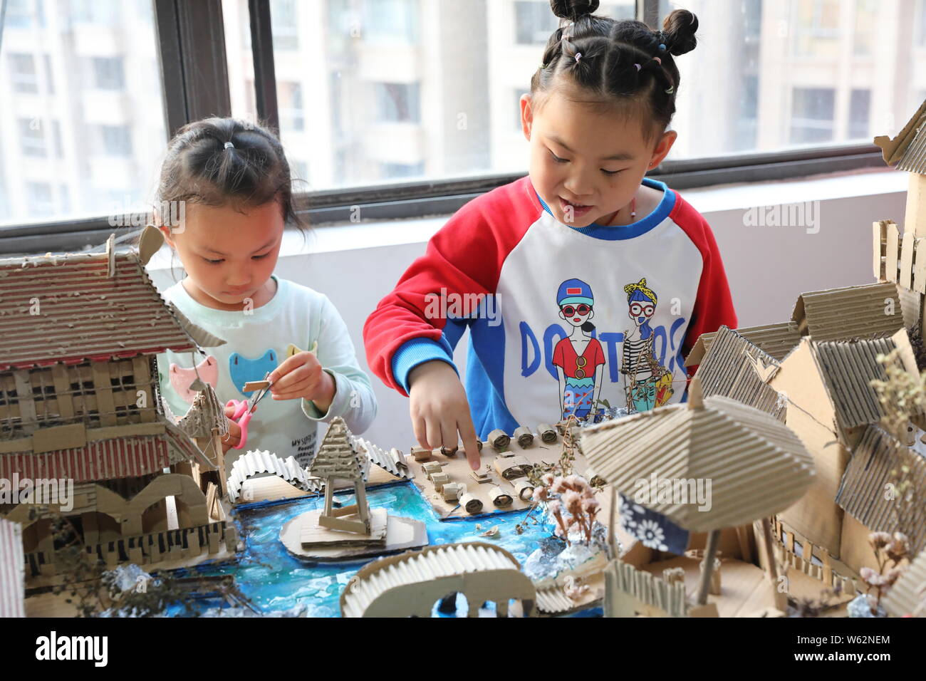 Chinese children and their teachers use recycled package boxes to make ...