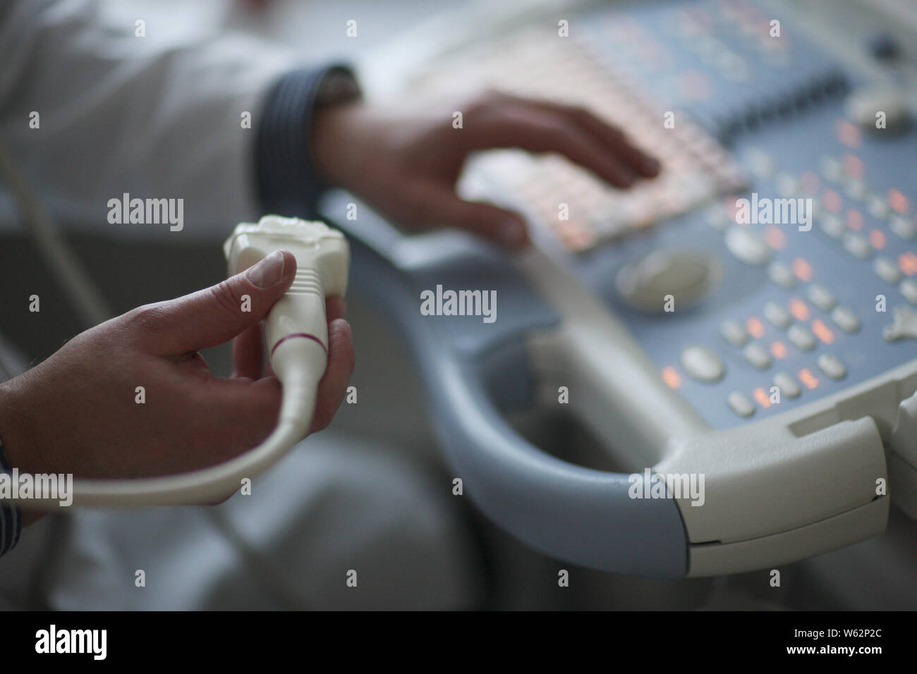 Doctor performs ultrasound examination of the patient Stock Photo - Alamy