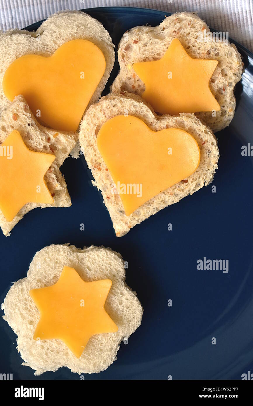Small canape sandwiches of yellow cheese and toast bread cut in shapes ...