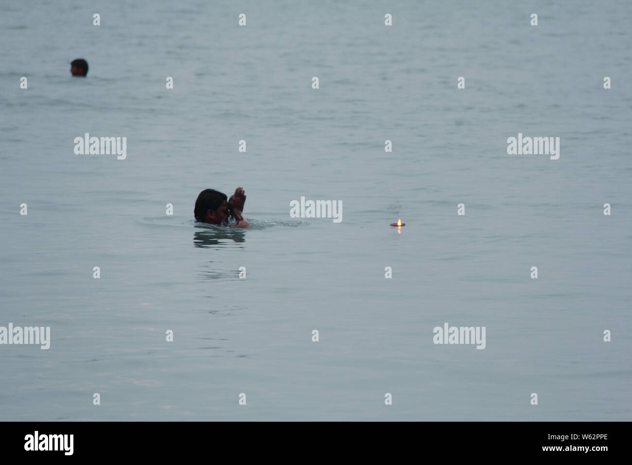 Man praying in a river Stock Photo - Alamy