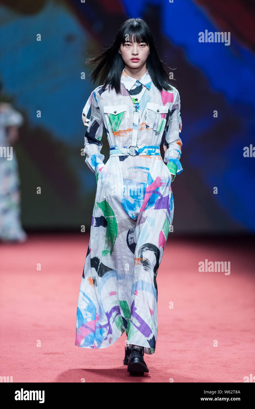 A model displays a new creation at the fashion show of Anirac during the Shanghai Fashion Week ...