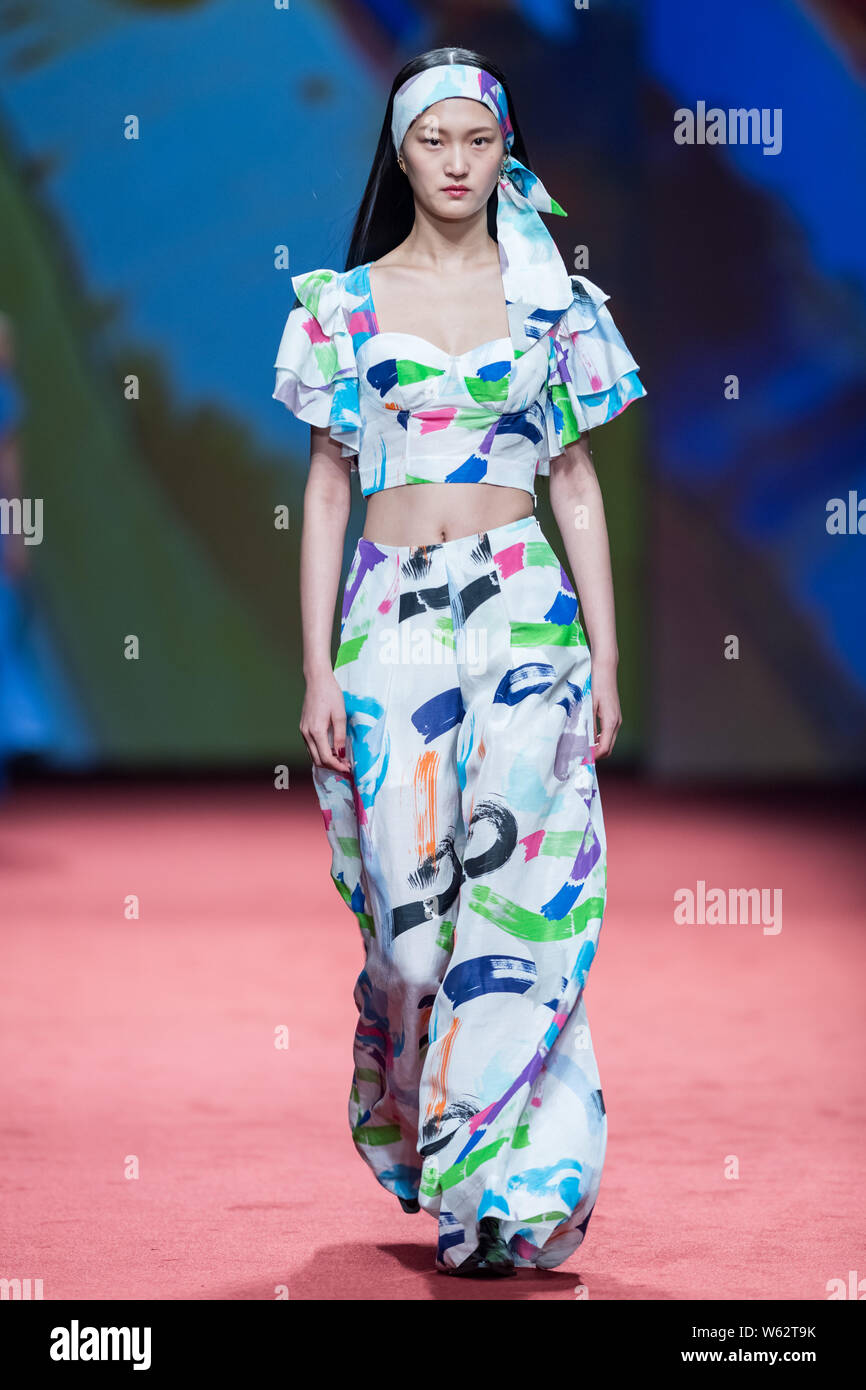 A model displays a new creation at the fashion show of Anirac during the Shanghai Fashion Week ...