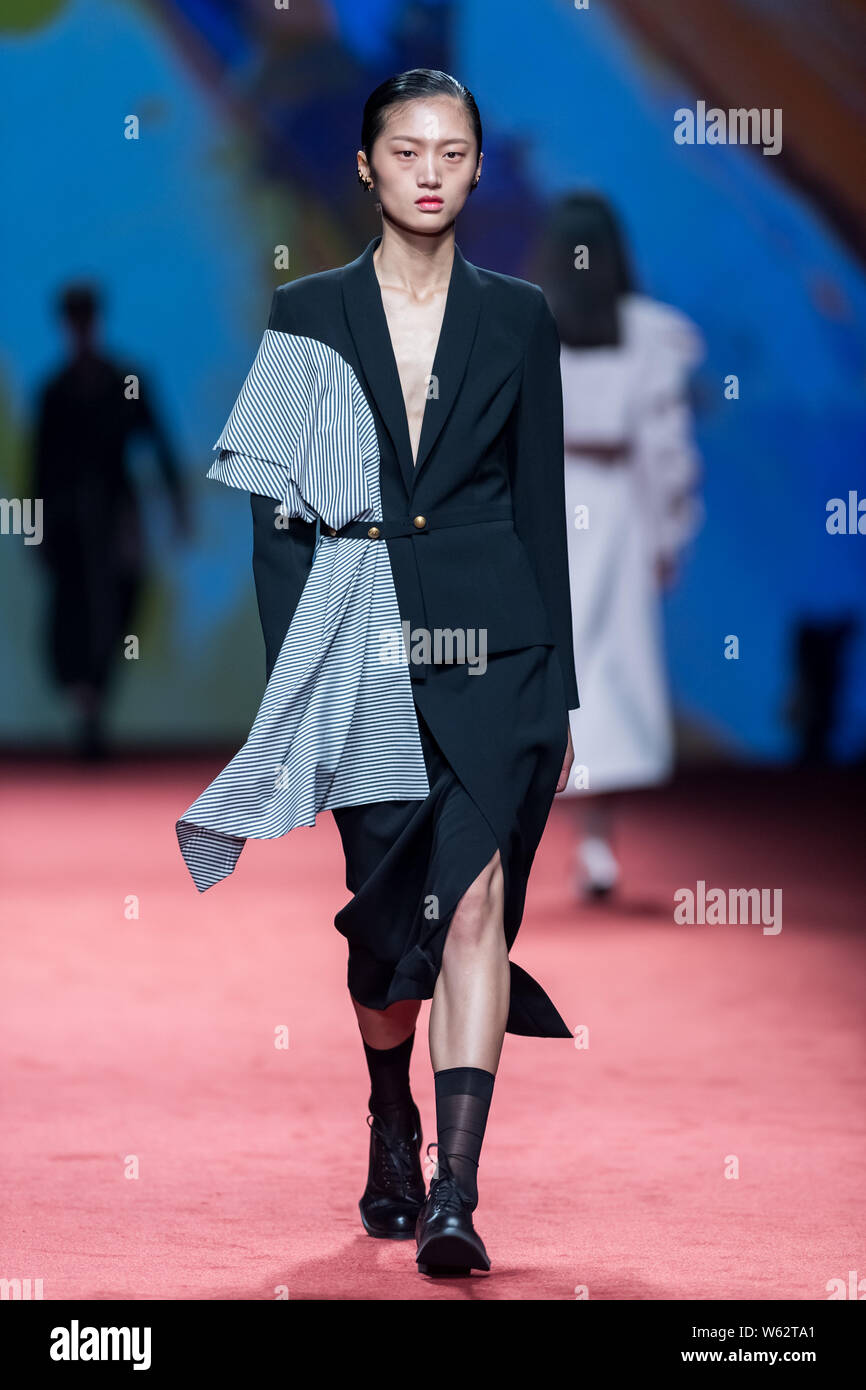 A model displays a new creation at the fashion show of Anirac during the Shanghai Fashion Week ...