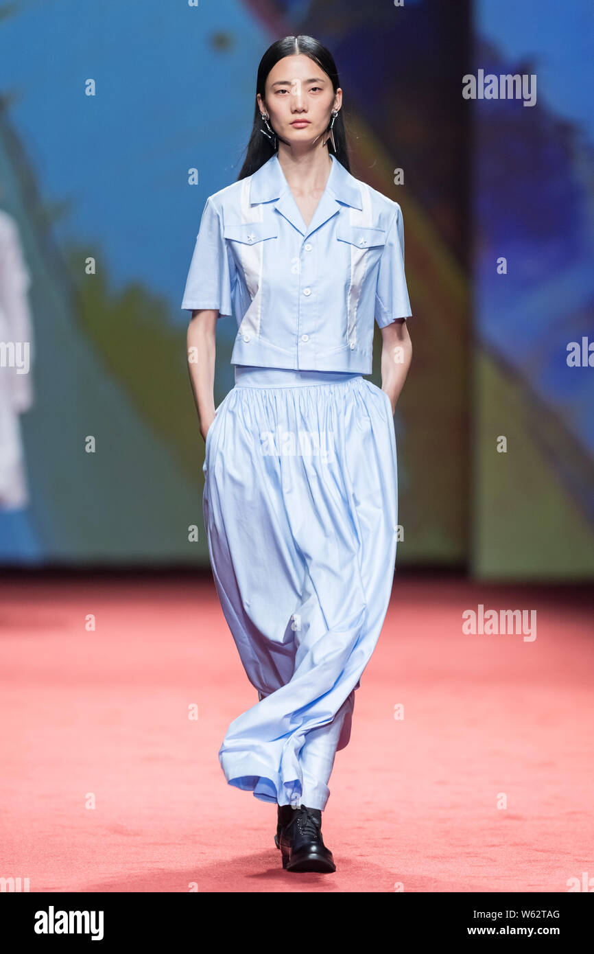 A model displays a new creation at the fashion show of Anirac during the Shanghai Fashion Week ...