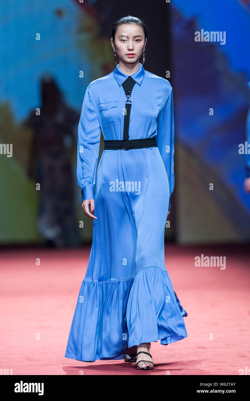 A model displays a new creation at the fashion show of Anirac during the Shanghai Fashion Week ...