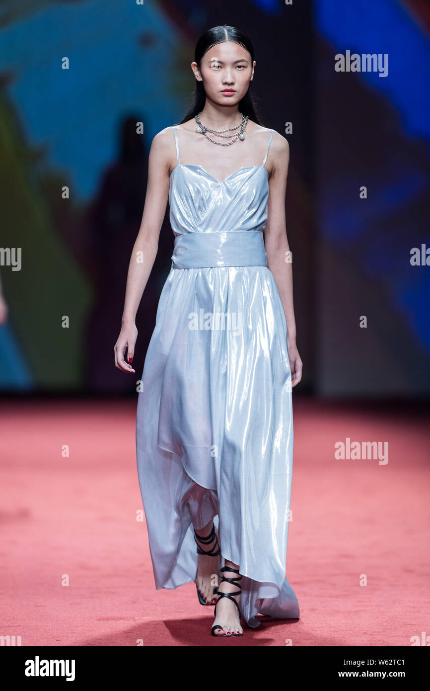 A model displays a new creation at the fashion show of Anirac during the Shanghai Fashion Week ...