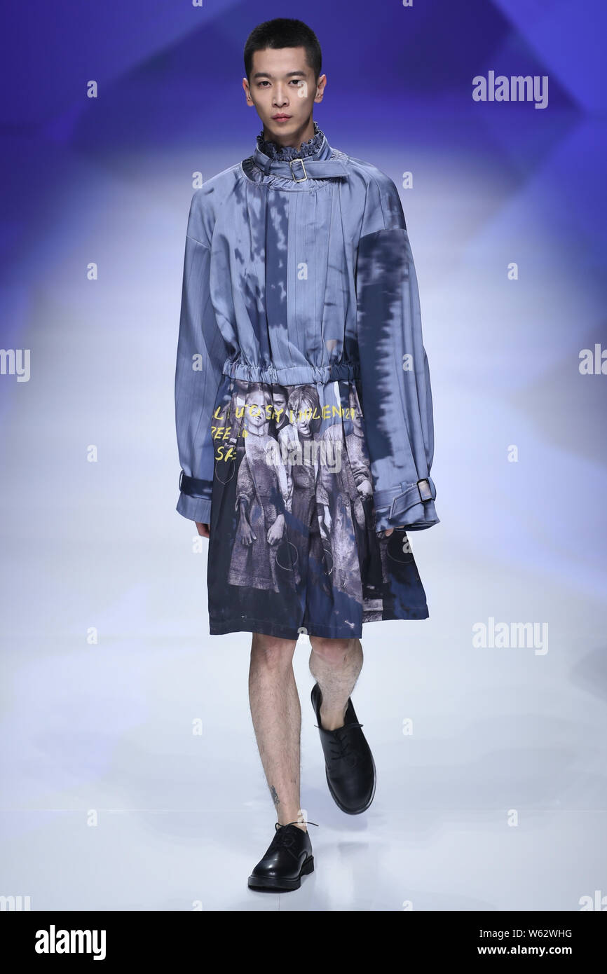 A model displays a new creation at the fashion show of Asahi Kasei ...