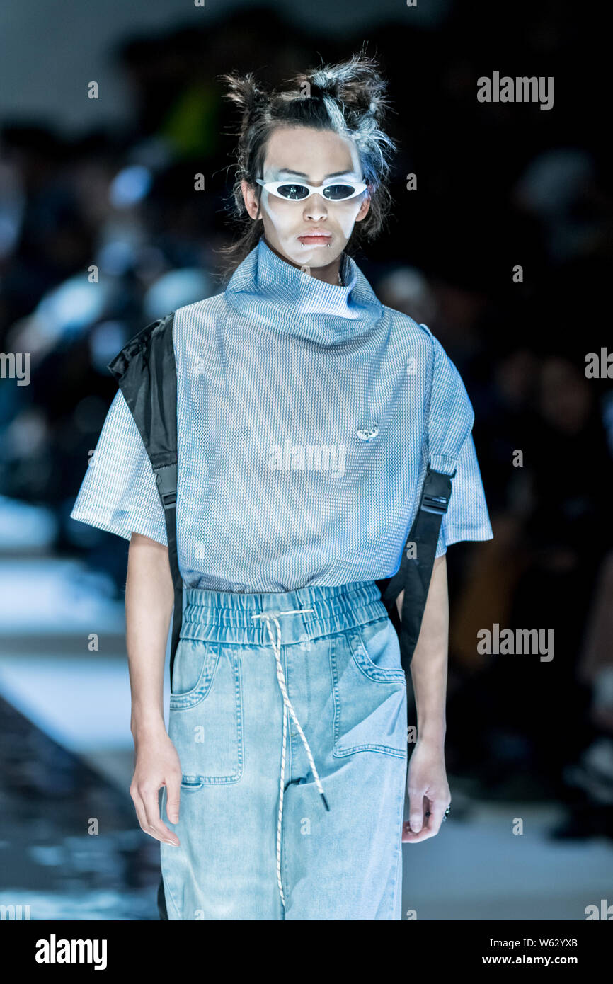 A model displays a new creation at the fashion show of F/FFFFFF during the Shanghai Fashion Week ...