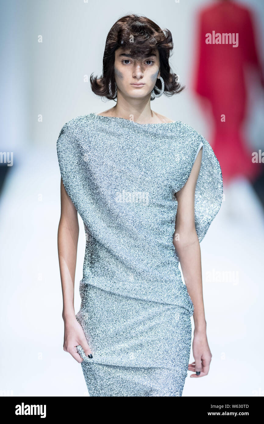 A model displays a new creation at the fashion show of YOEYYOU during ...