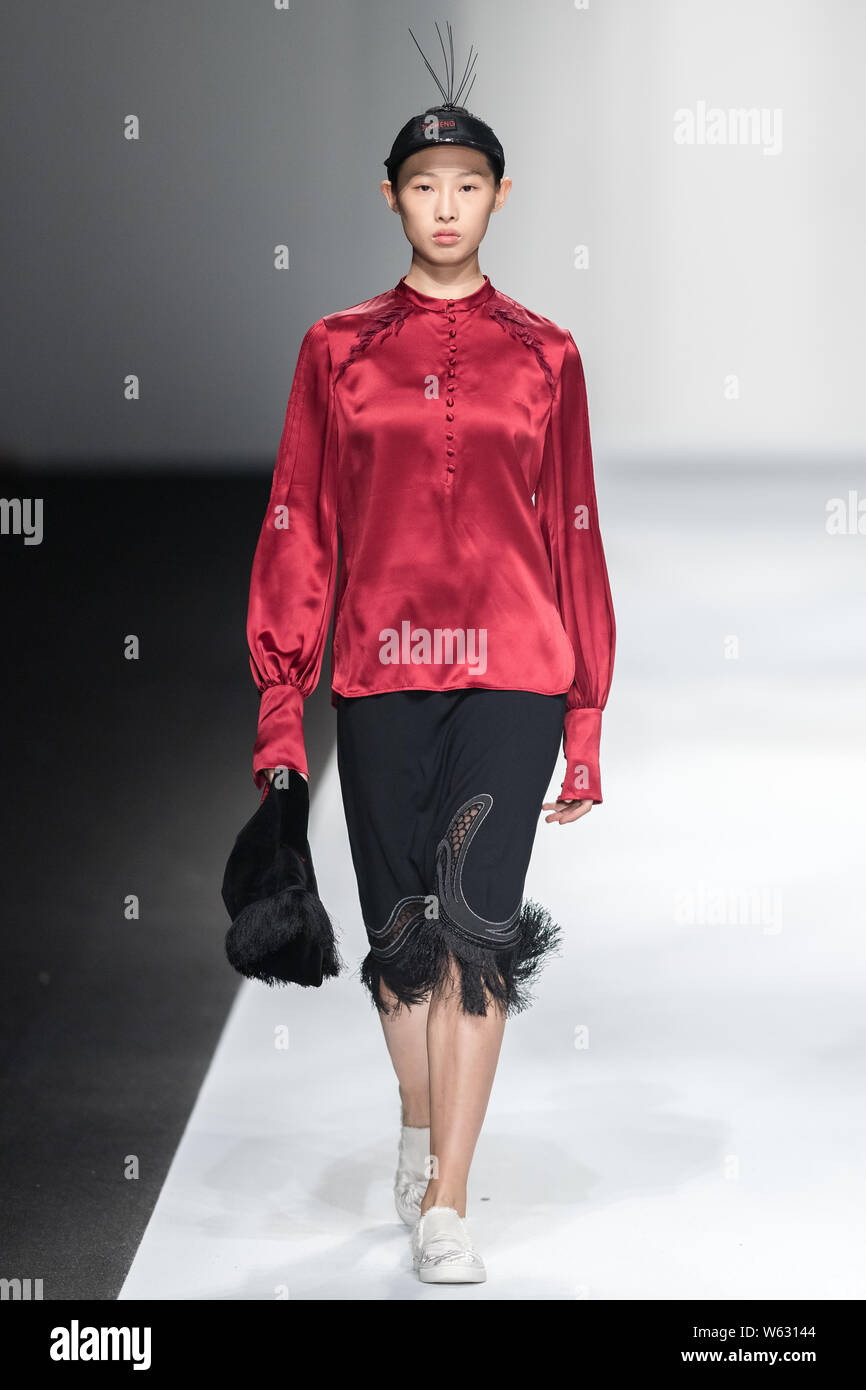A model displays a new creation at the fashion show of Ji Cheng during ...