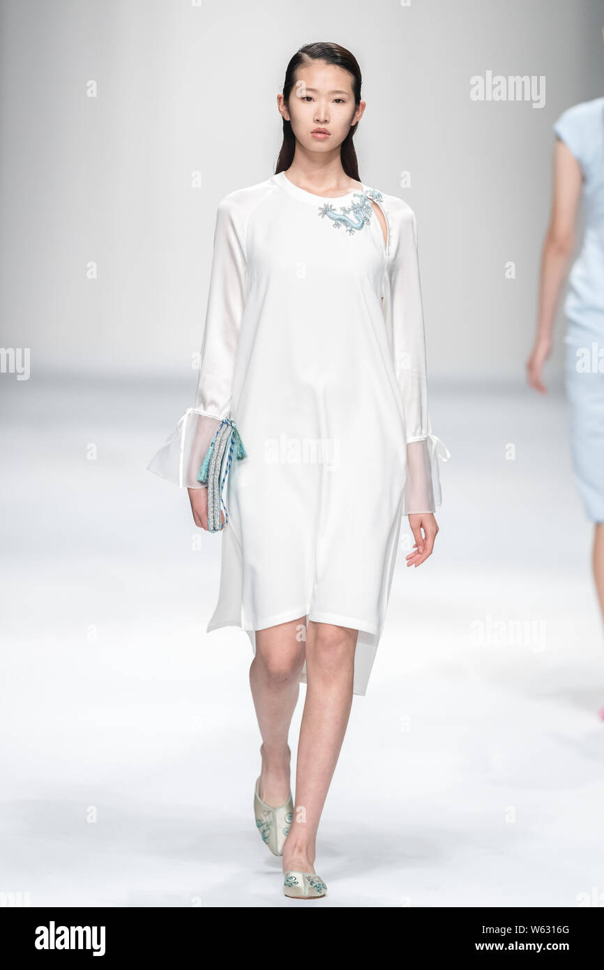 A model displays a new creation at the fashion show of Ji Cheng during ...