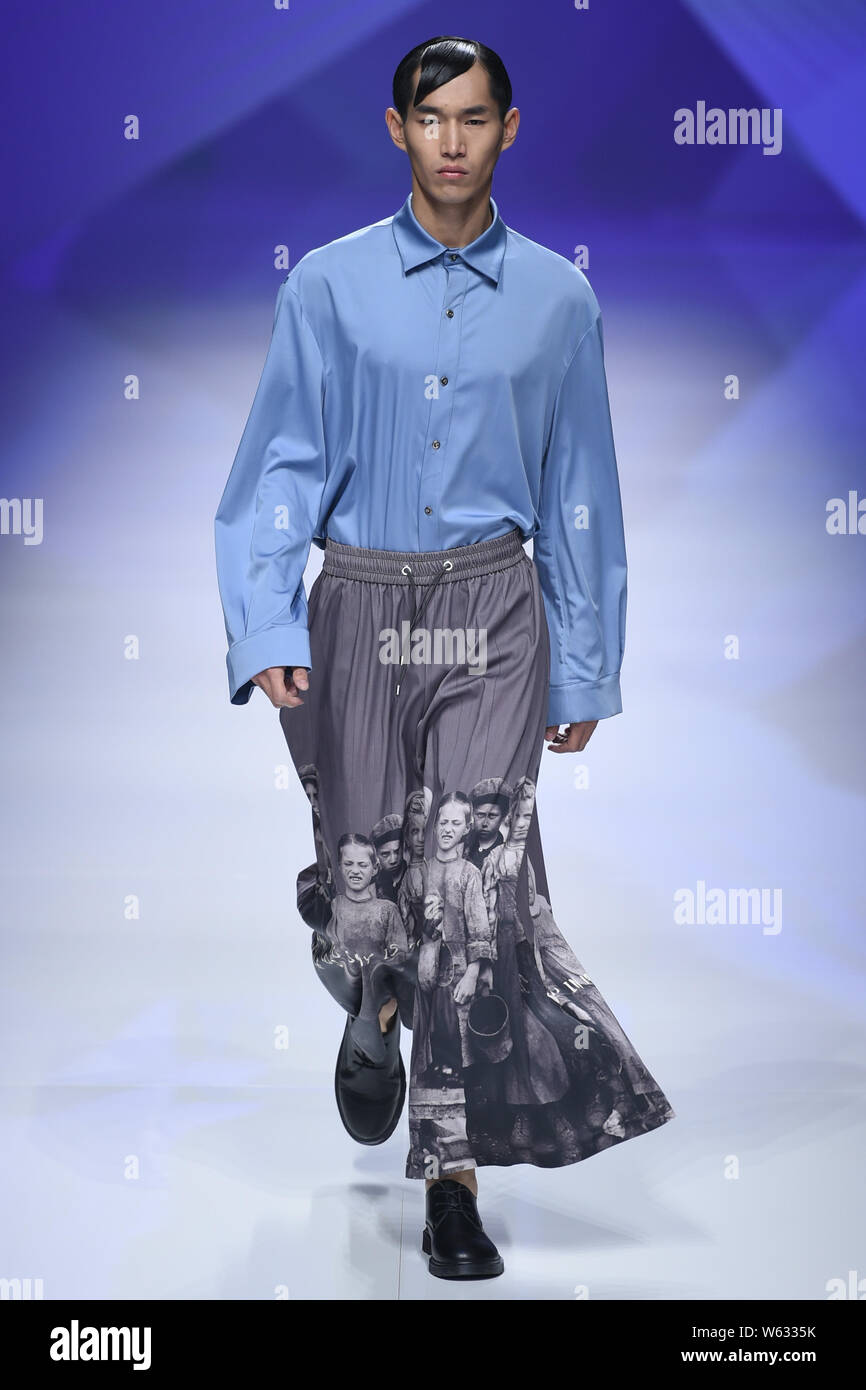 A model displays a new creation at the fashion show of Asahi Kasei ...
