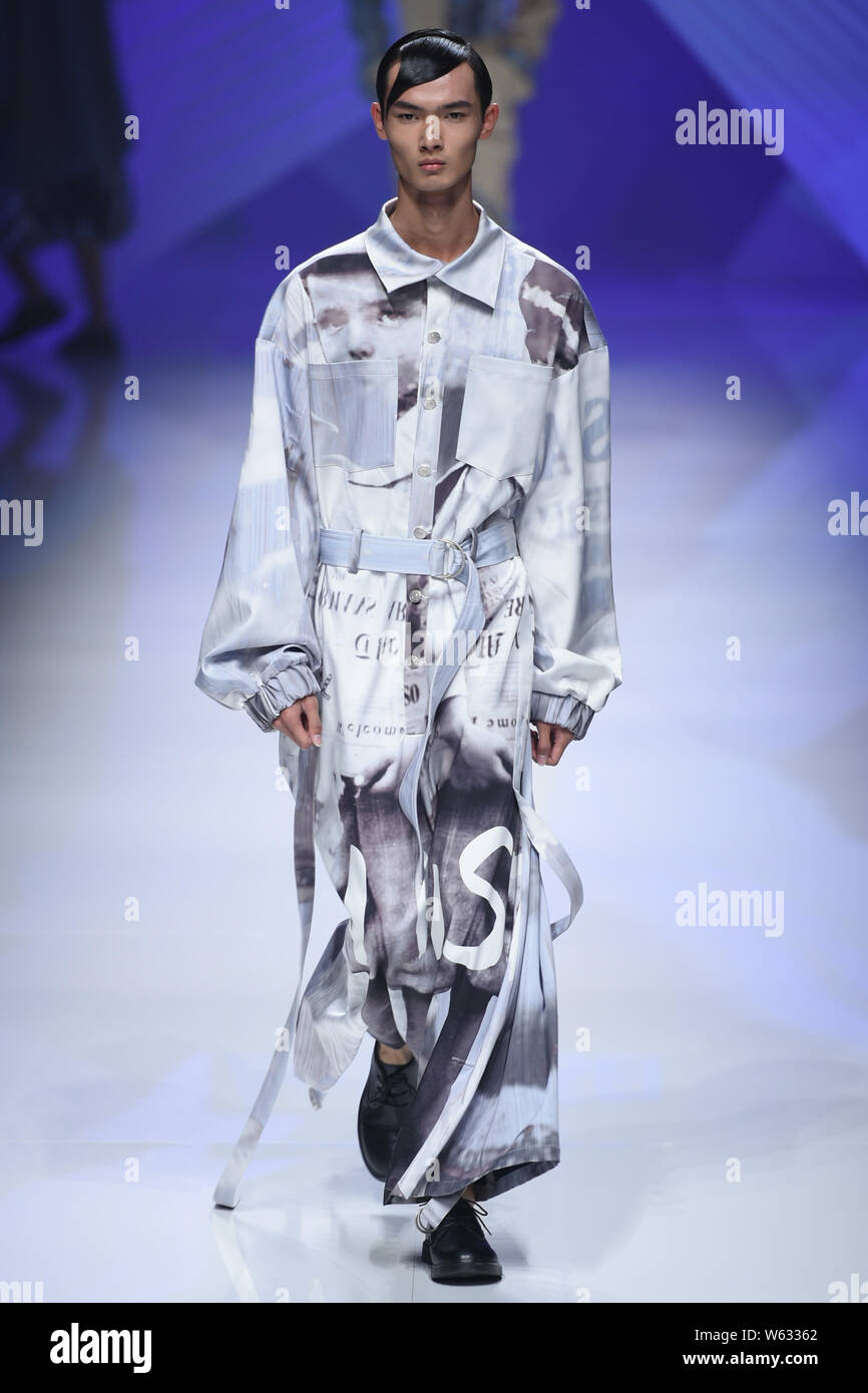 A model displays a new creation at the fashion show of Asahi Kasei ...