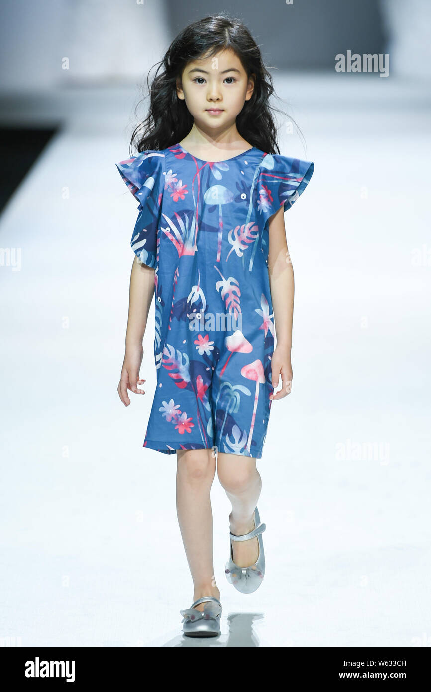 A model displays a new creation at the fashion show of Qimoo during the ...