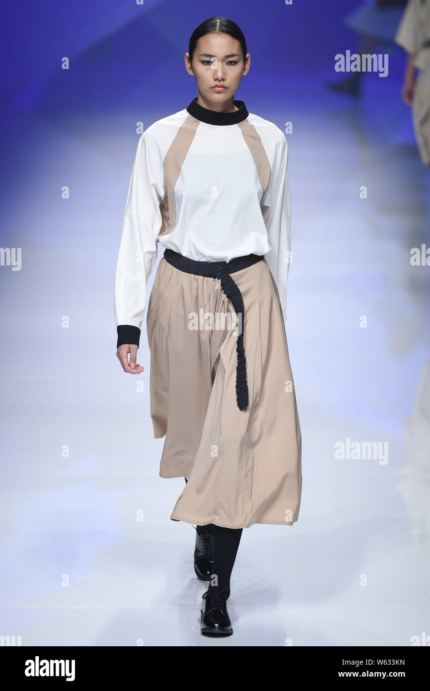 A model displays a new creation at the fashion show of Asahi Kasei ...