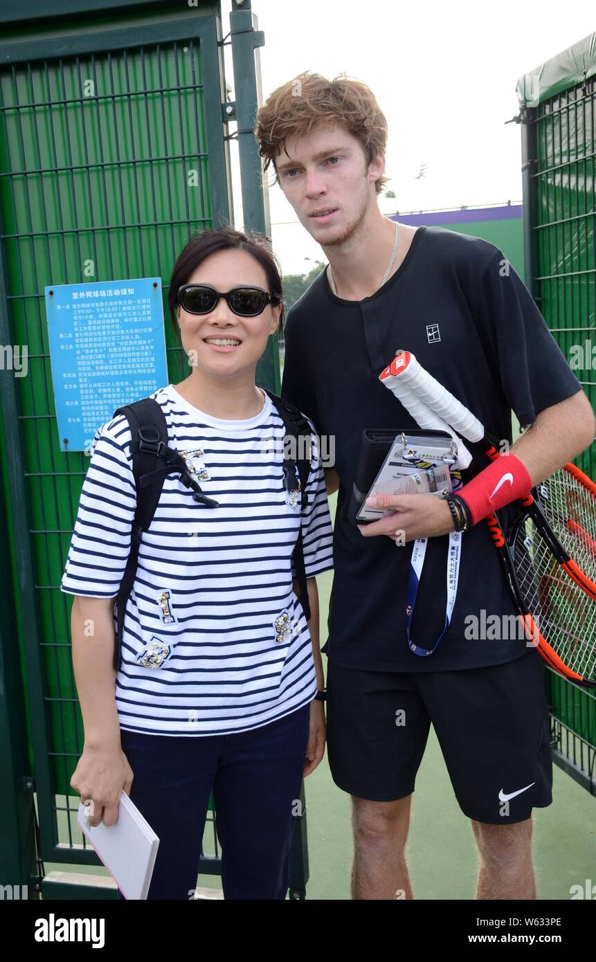 Russian tennis player Andrey Rublev poses with a fan for a photo after ...