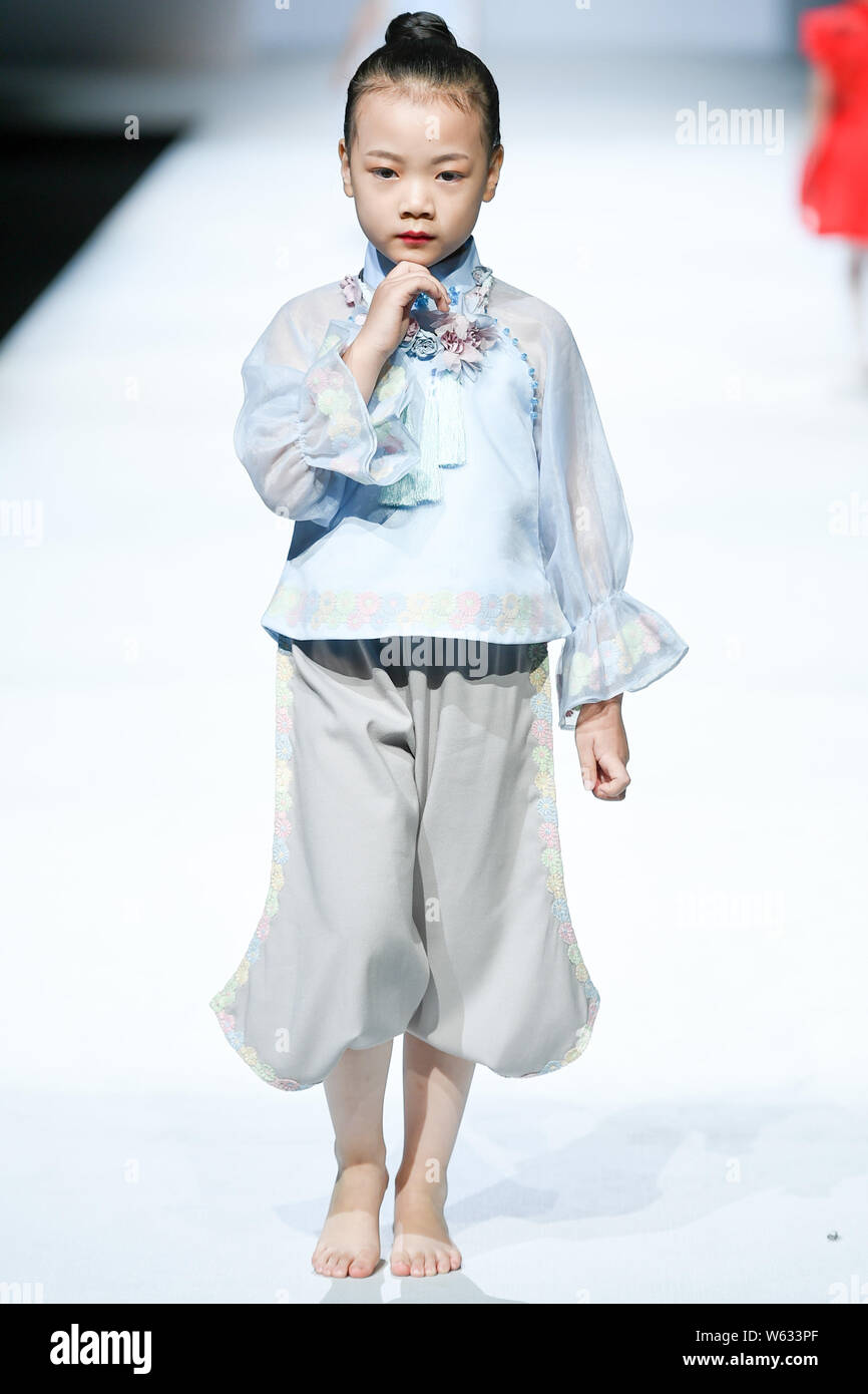 A model displays a new creation at the fashion show of THE YIAN STUDIOS ...