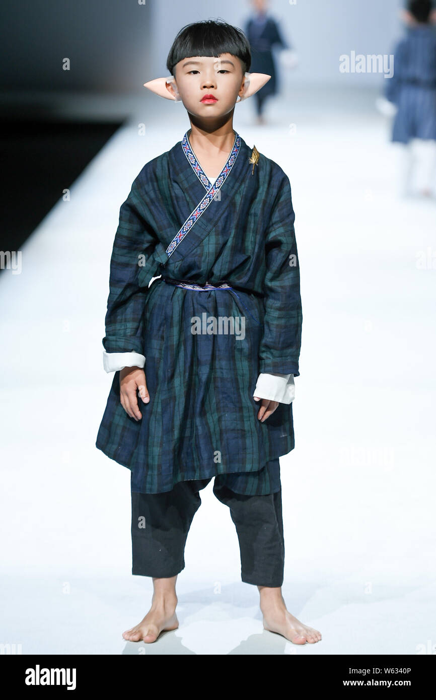 A model displays a new creation at the fashion show of THE YIAN STUDIOS ...