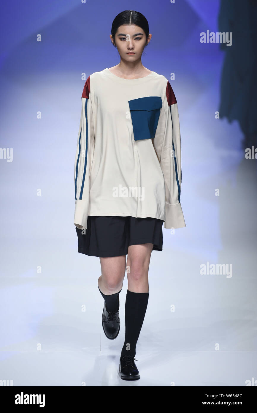 A model displays a new creation at the fashion show of Asahi Kasei ...