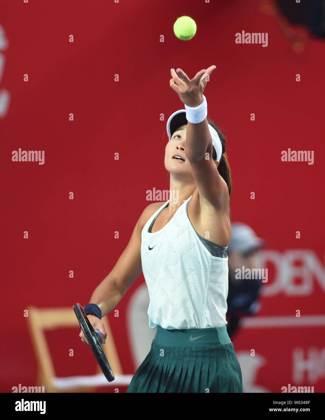 Zhang Ling of Chinese Hong Kong serves against Wang Qiang of China in ...